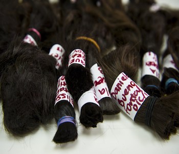 Bootleg Rapper Throws Weave Bundles In Strip Club